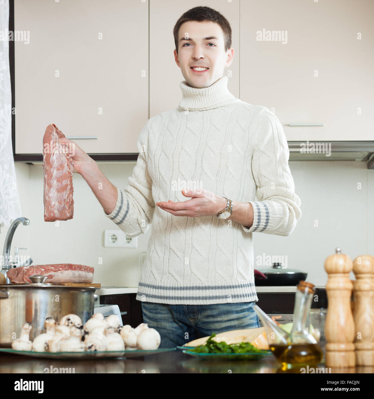 man cooking french-style meat at kitchen Stock Photo - Alamy