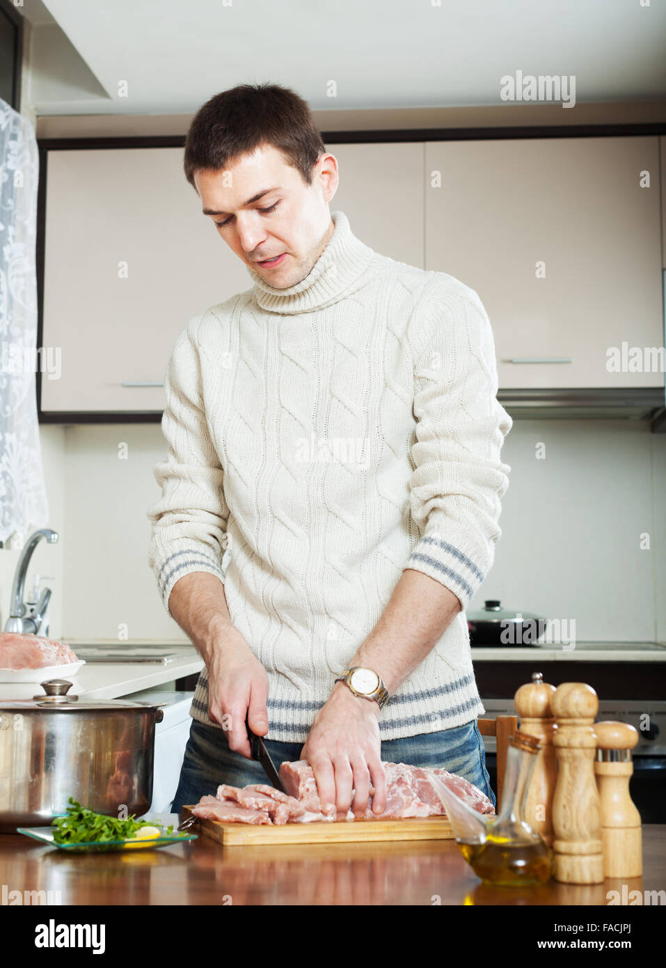 Guy cooking meat at domestic kitchen Stock Photo - Alamy