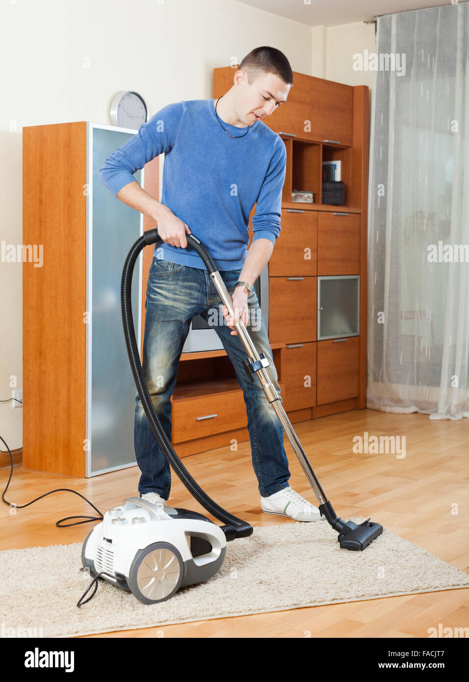 Man home using vacuum cleaner hi-res stock photography and images - Alamy