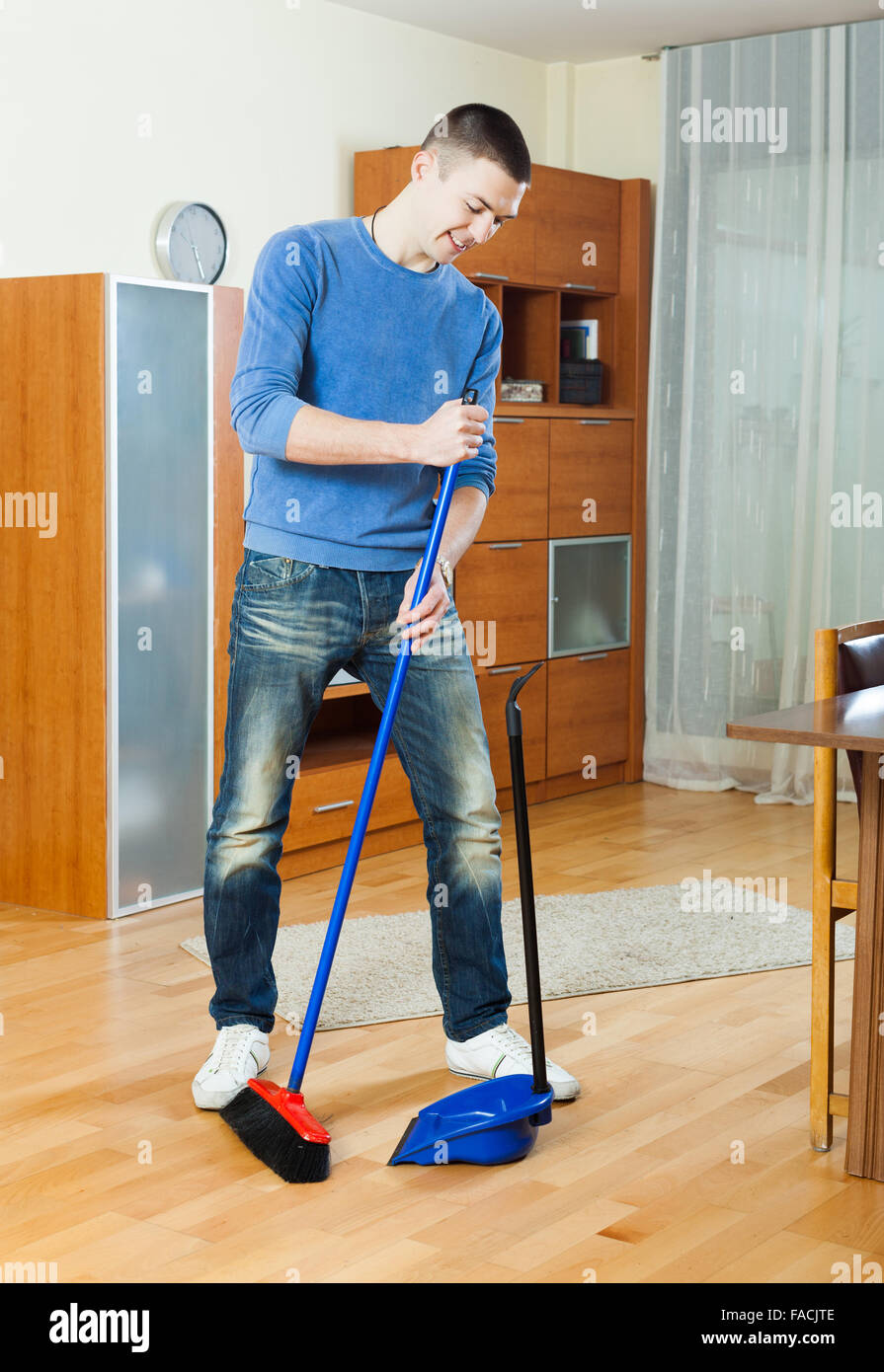 man sweeping the floor in living room at home Stock Photo - Alamy