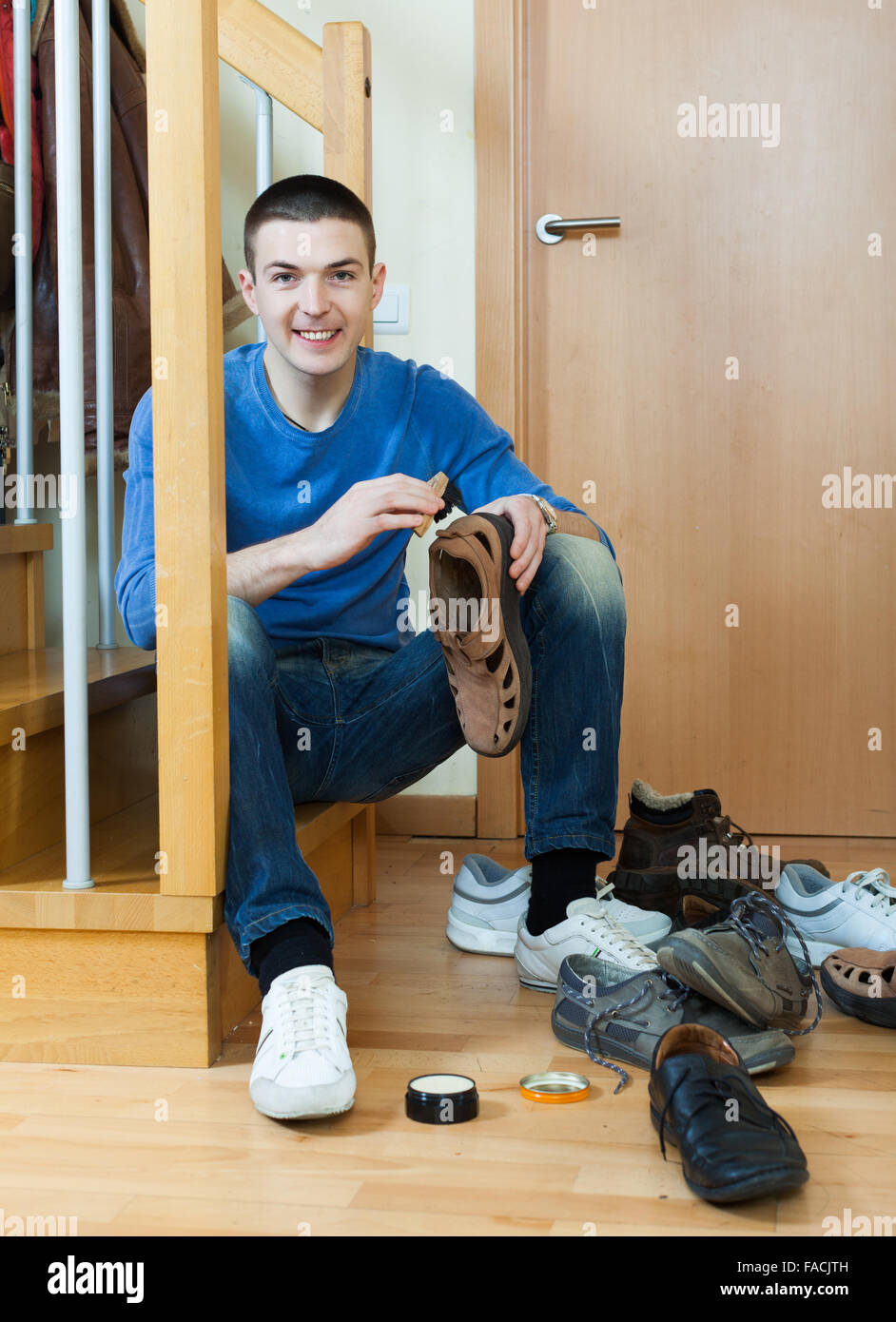 Smiling guy with shoes at home Stock Photo - Alamy
