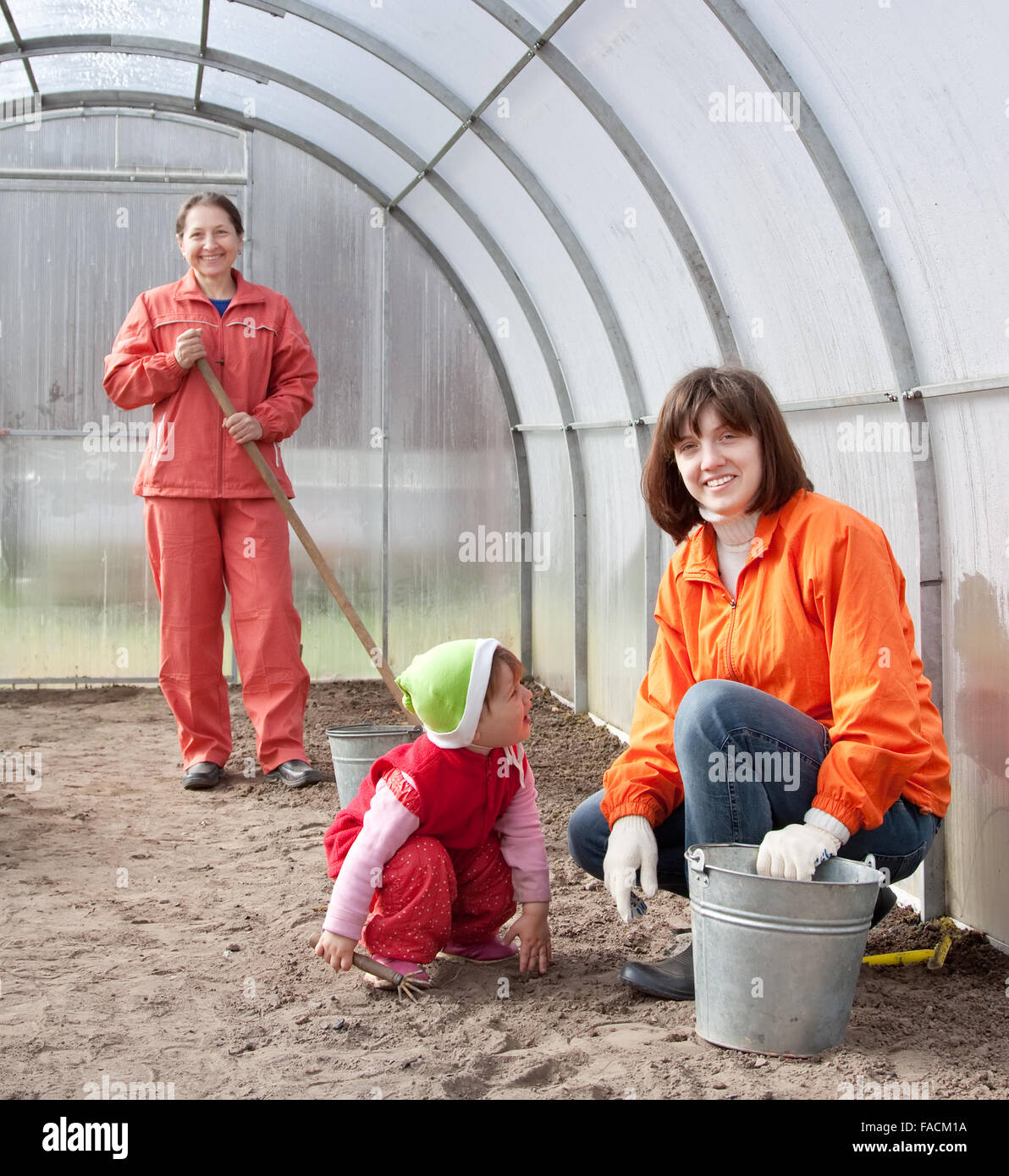 Happy family works in greenhouse Stock Photo - Alamy Happy family works in greenhouse Stock Photo - Alamy