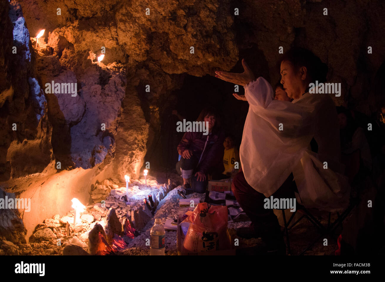 Yuta (priestess) Ayako Toguchi conducts prayers in a sea cave on Kouri ...