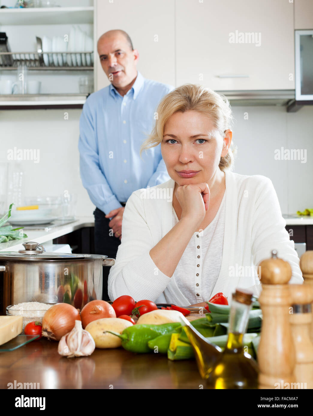 Sad senior man and mature woman during quarrel in kitchen Stock Photo ...