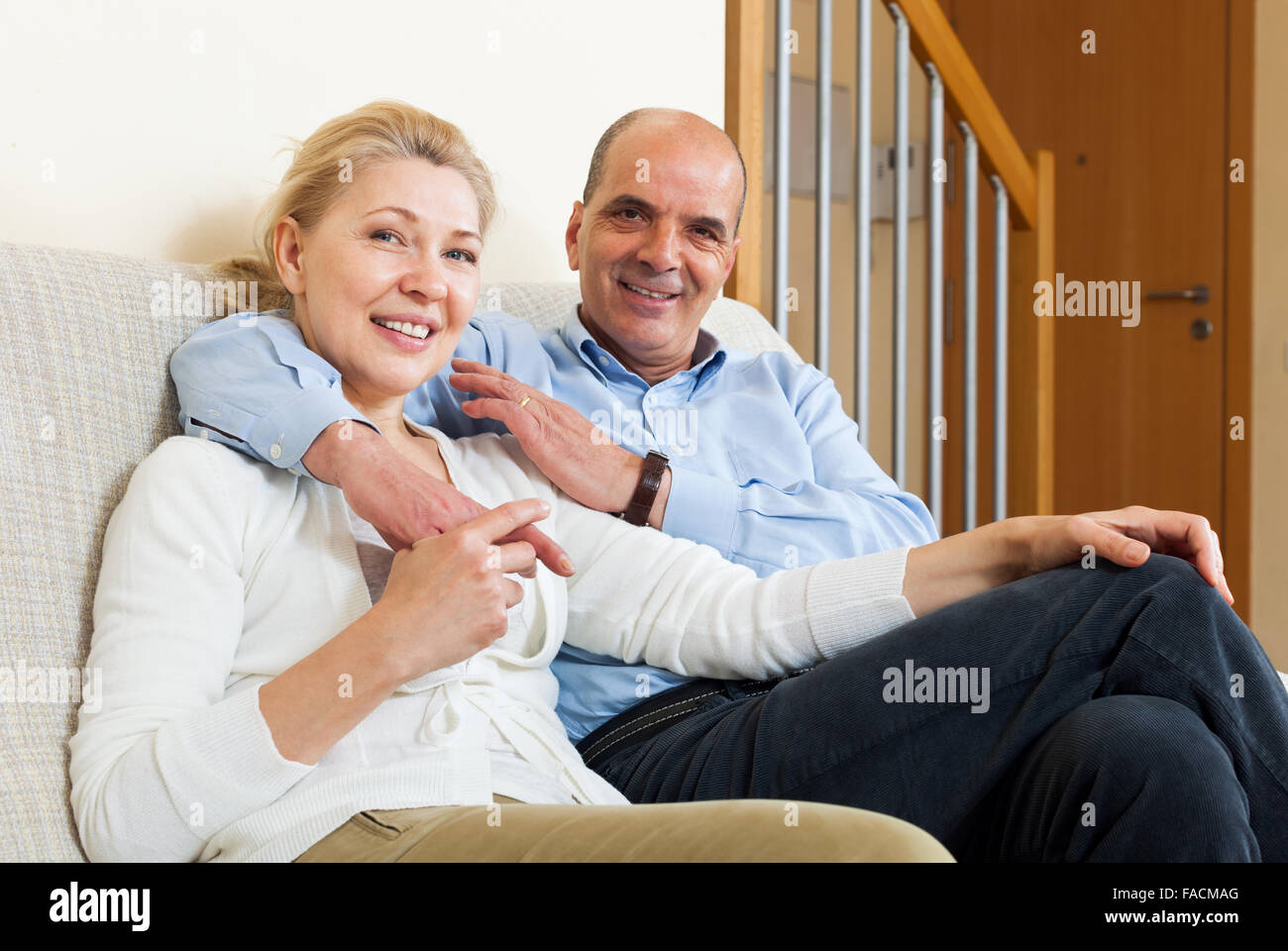 Happy couple flirting with love and hug together at home Stock Photo ...