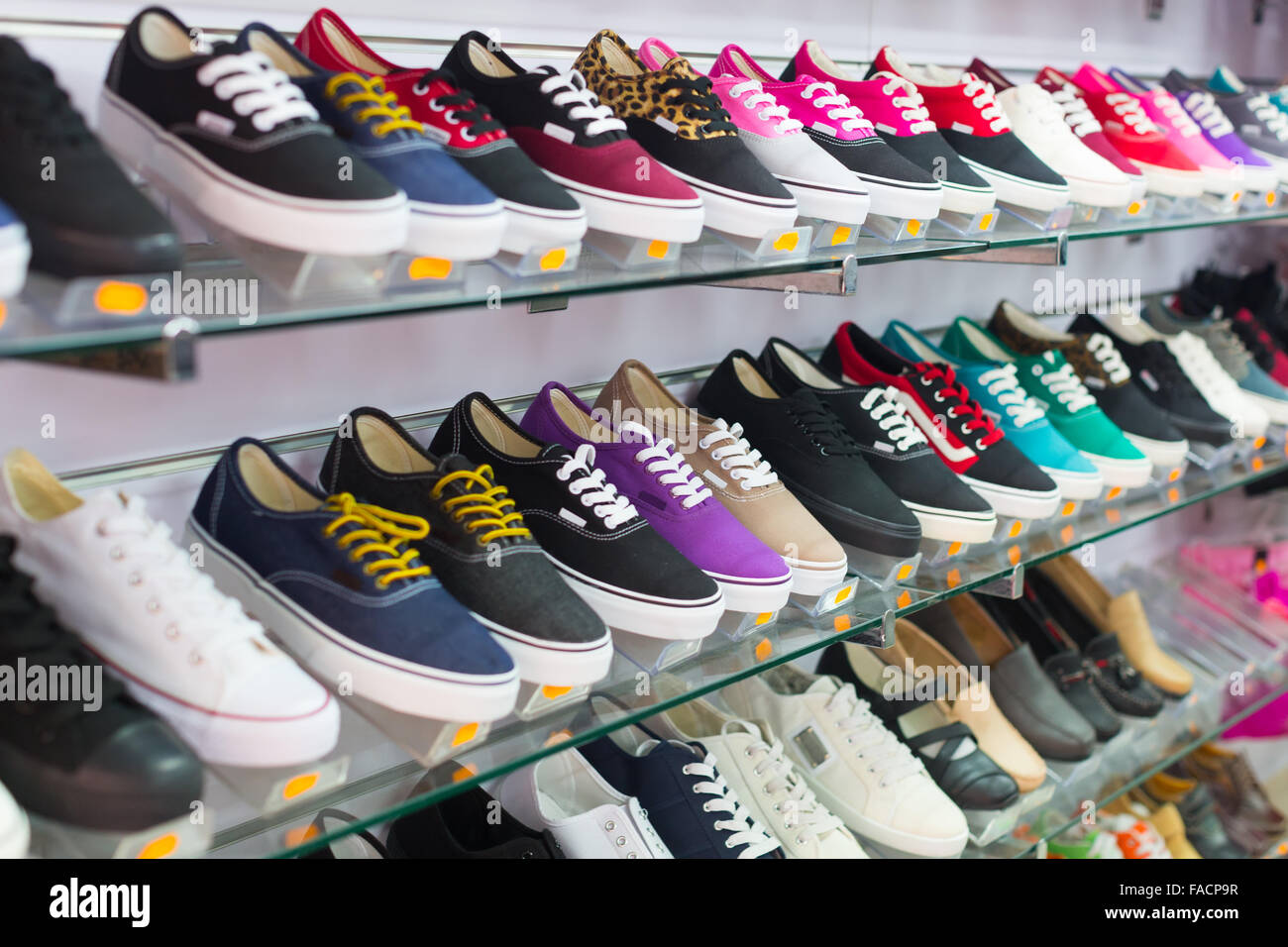 Shelves with casual shoes at store Stock Photo - Alamy