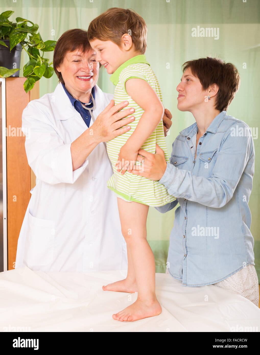 doctor examining child at clinic office Stock Photo - Alamy