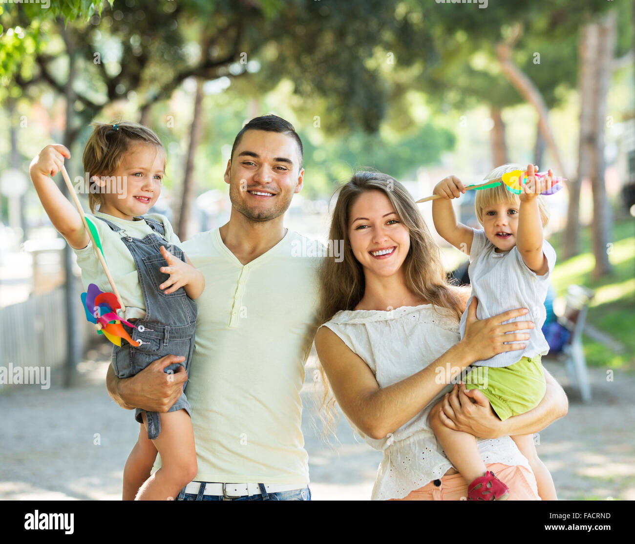 Parents walking with children on sunny vacation day at park Stock Photo ...