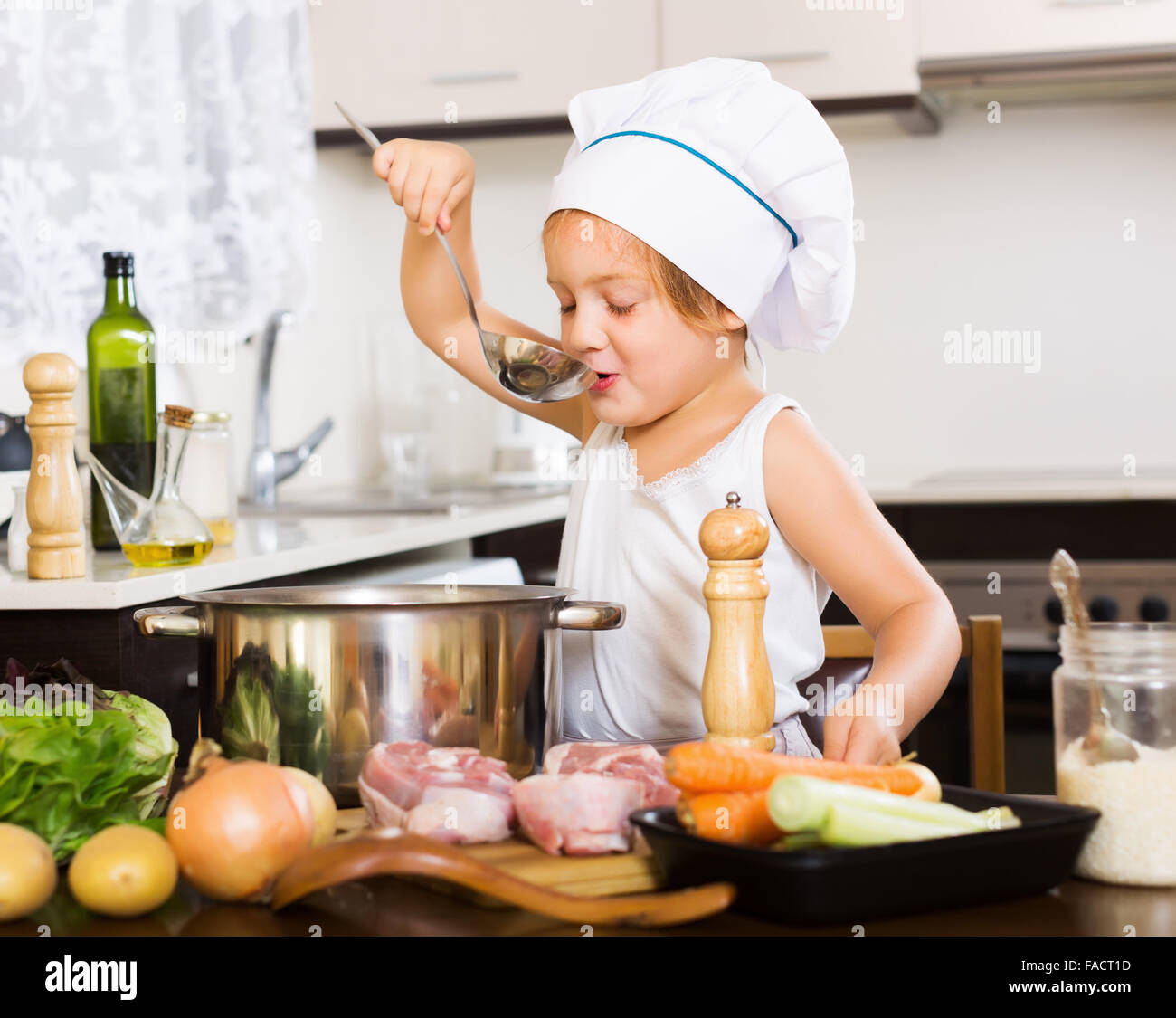 girl cooking soup with ladle at home Stock Photo - Alamy