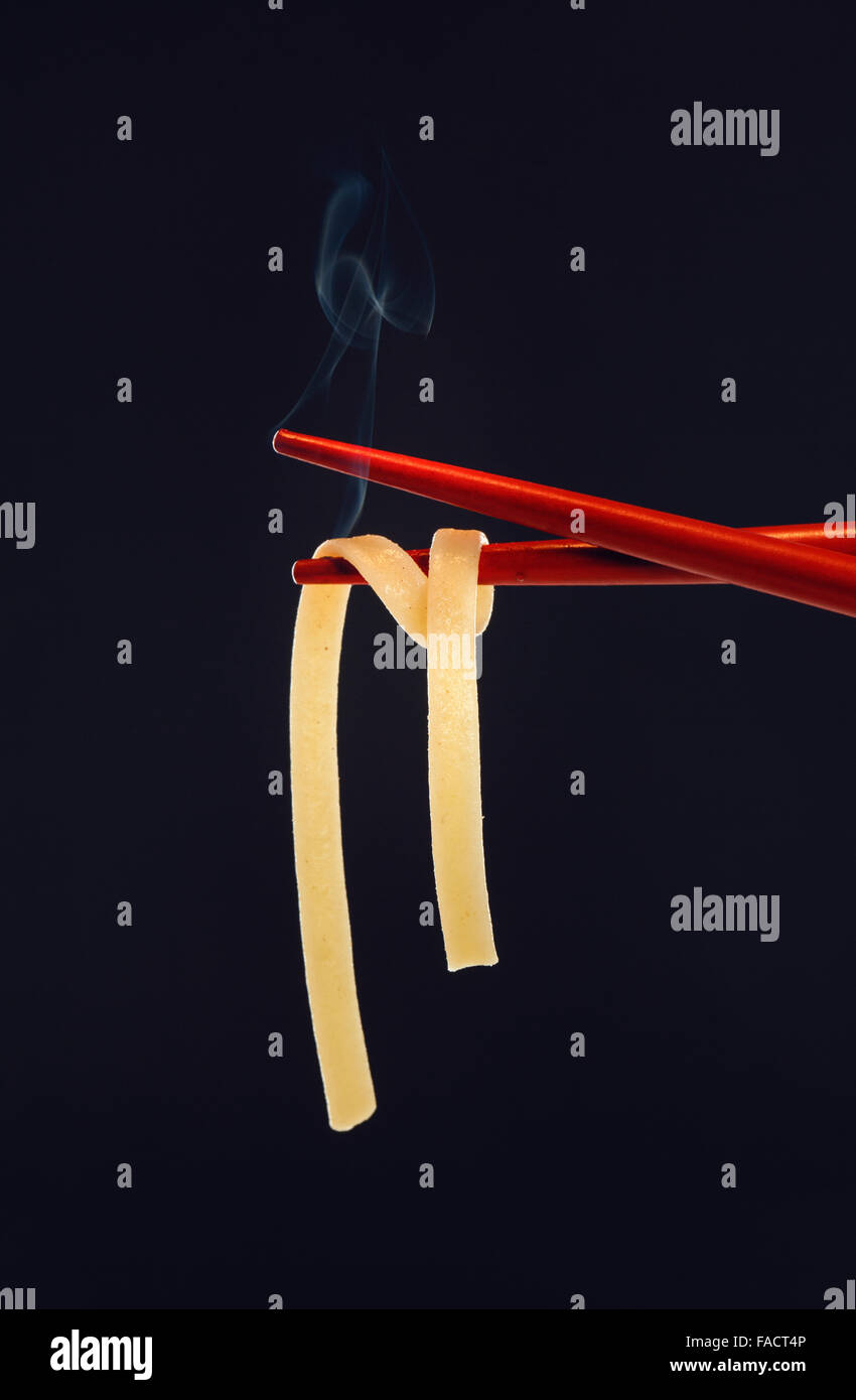Steamy single Noodle on Chopsticks Stock Photo - Alamy