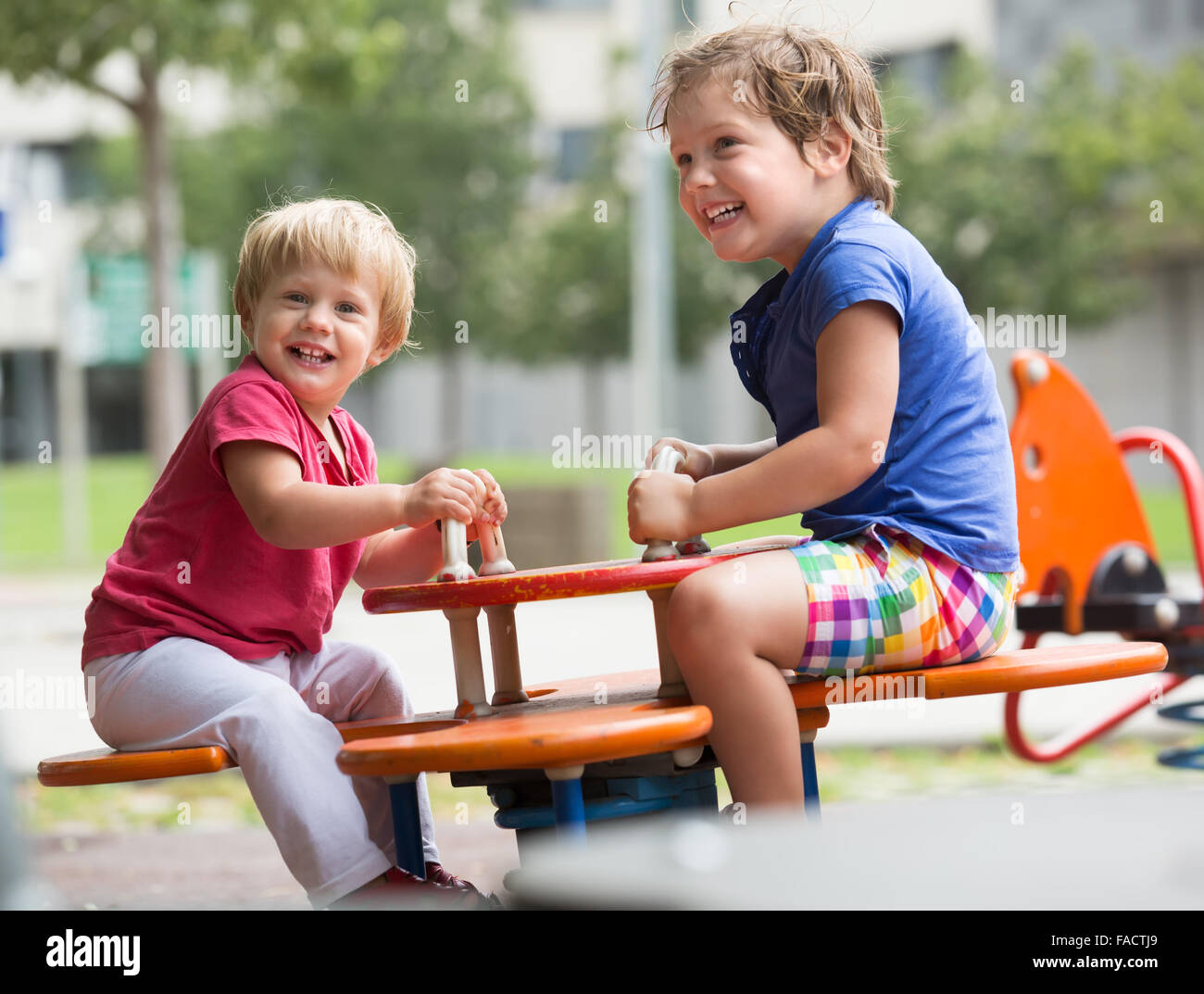 Happy excited little children having fun at city playground Stock Photo ...