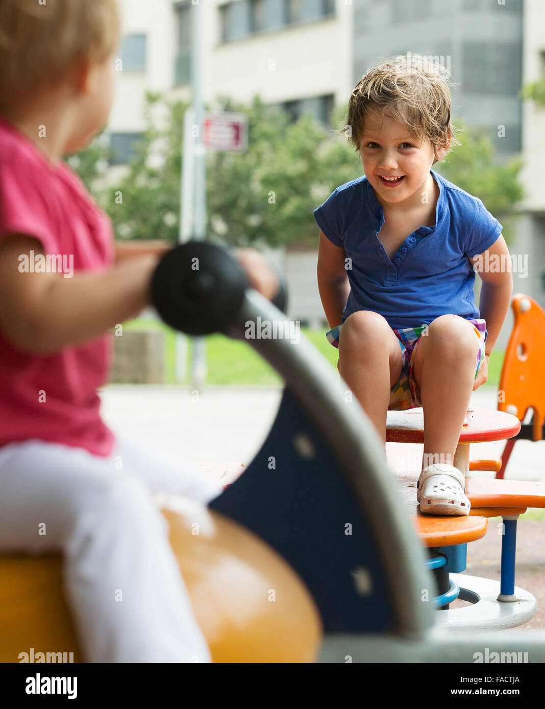 Happy smiling children having fun at playground Stock Photo - Alamy