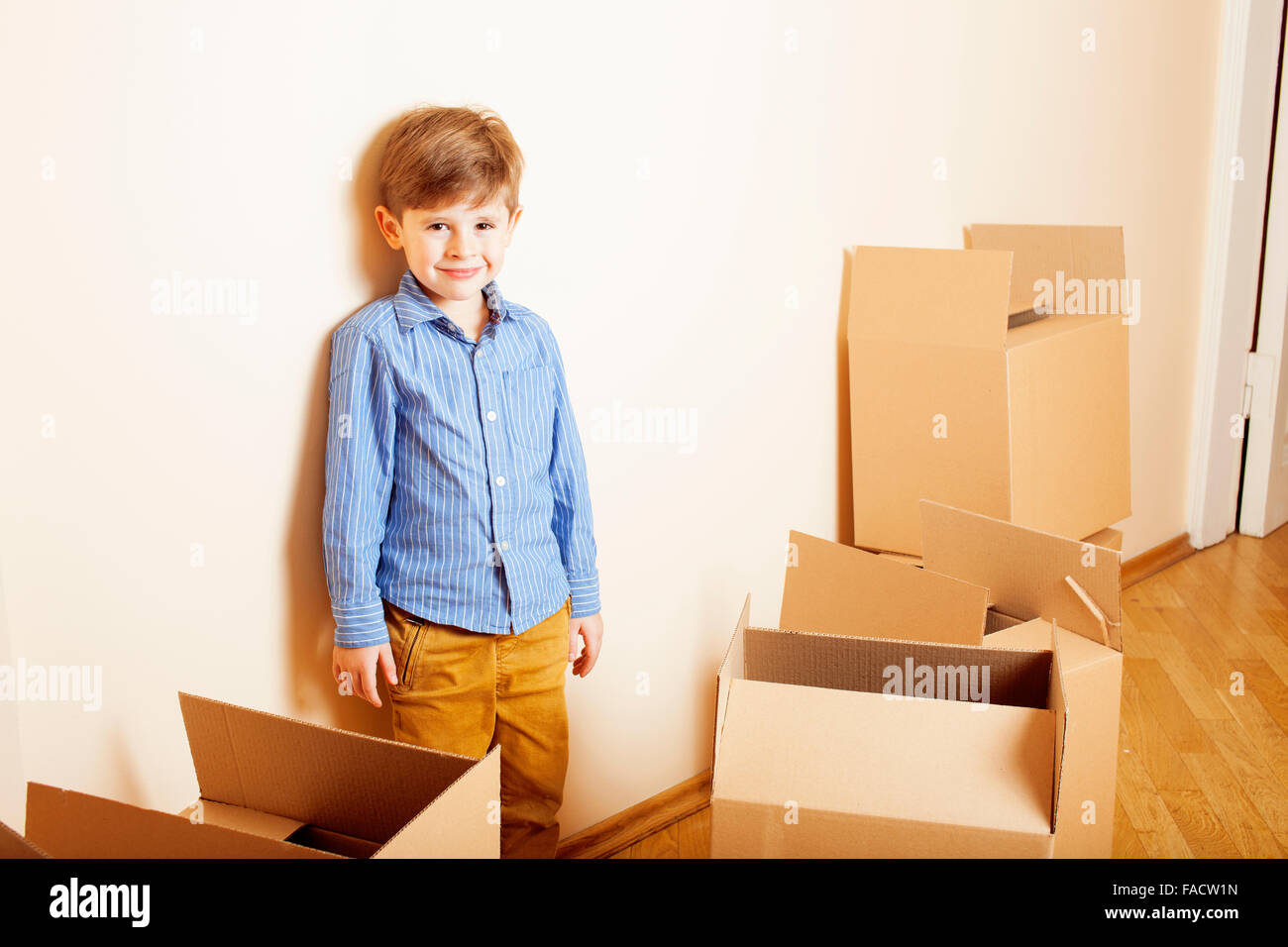 little cute boy in empty room, remoove to new house. home alone emong ...