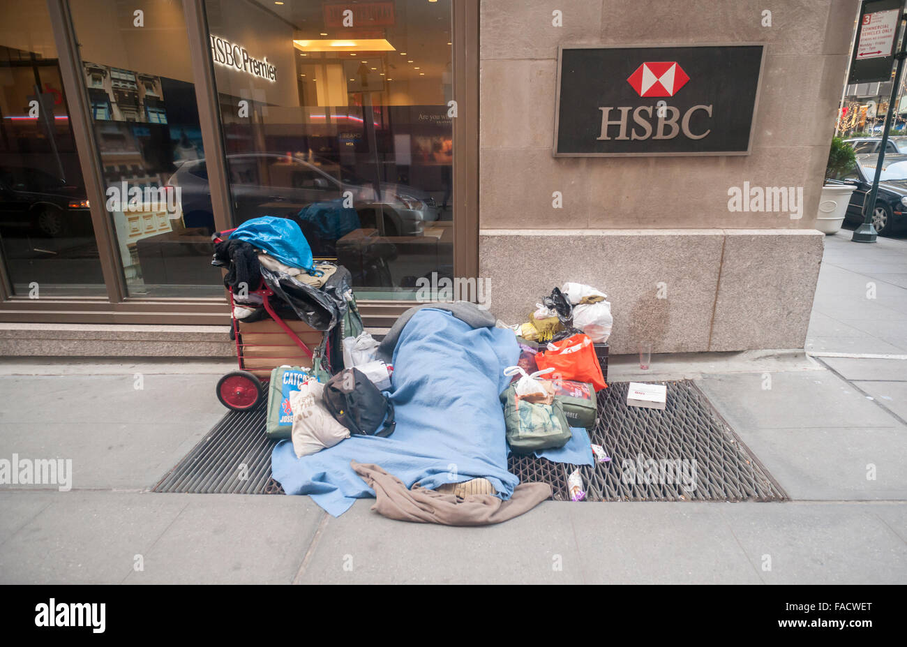 A homeless individual sleeps on the street in New York on Sunday ...