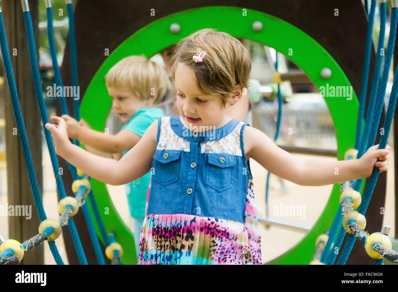 little girls climbing the ropes of challenge net Stock Photo - Alamy