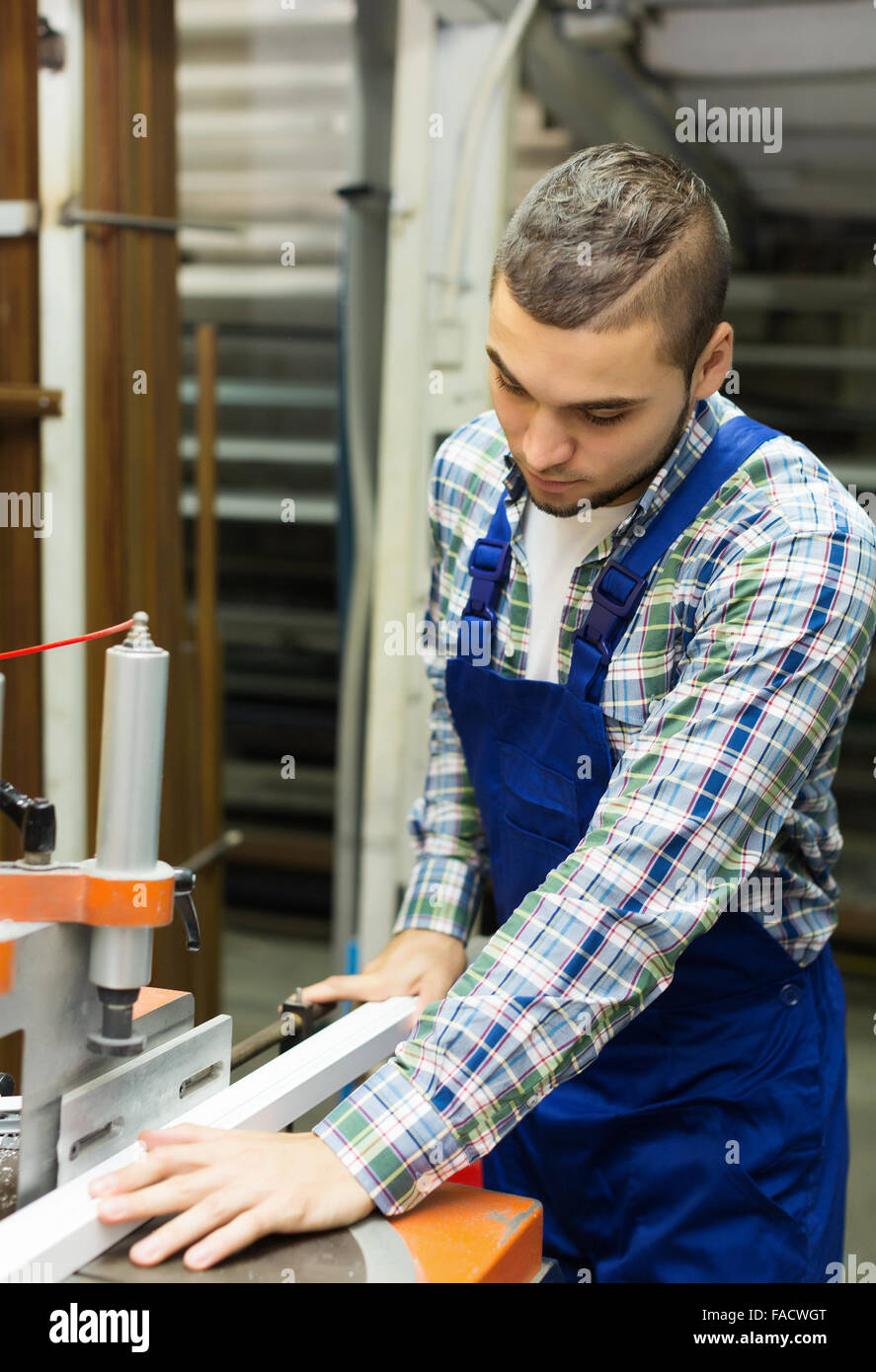 Worker working with PVC on machine at plant Stock Photo - Alamy