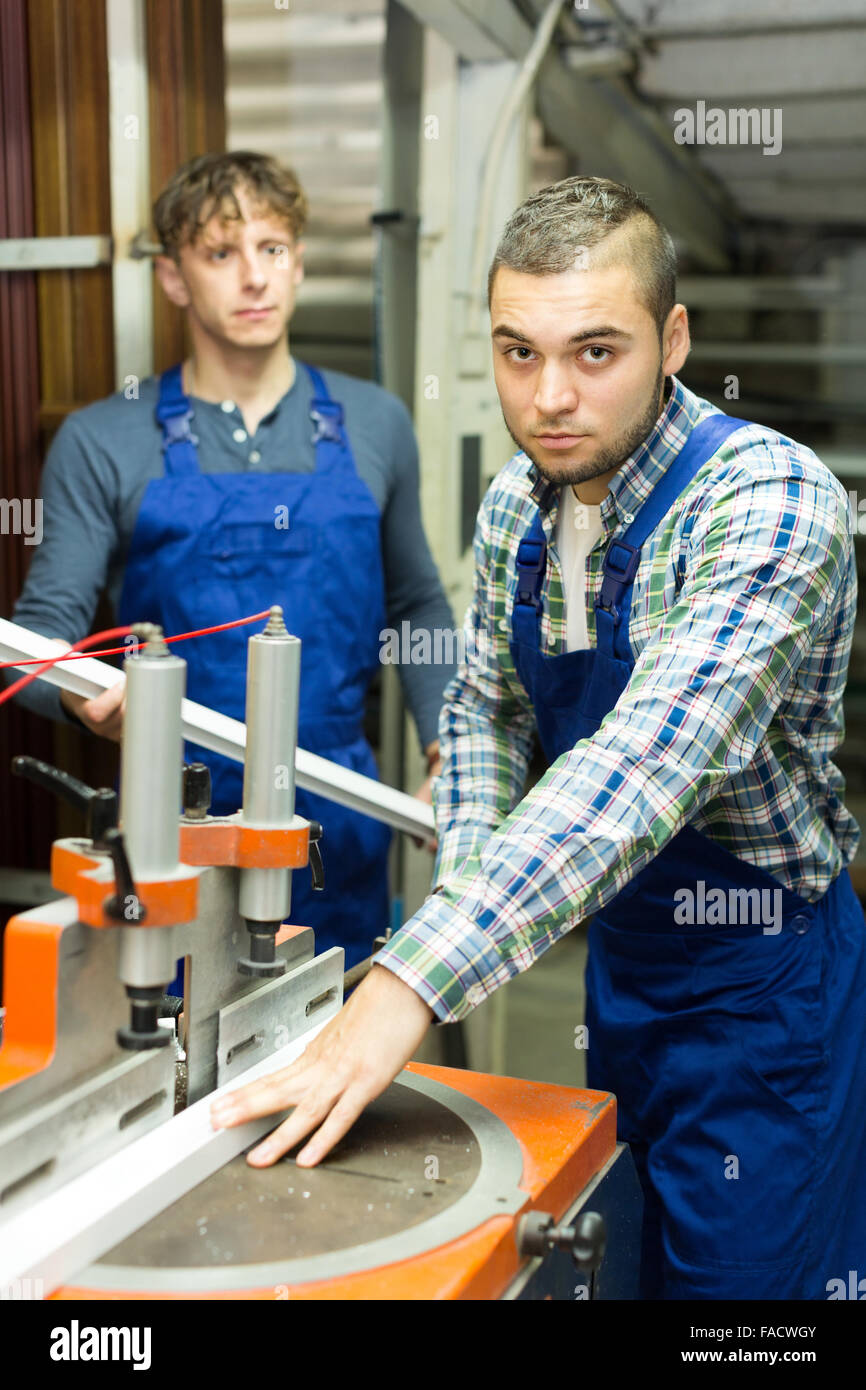 Couple of workmen near milling machine at factory Stock Photo - Alamy