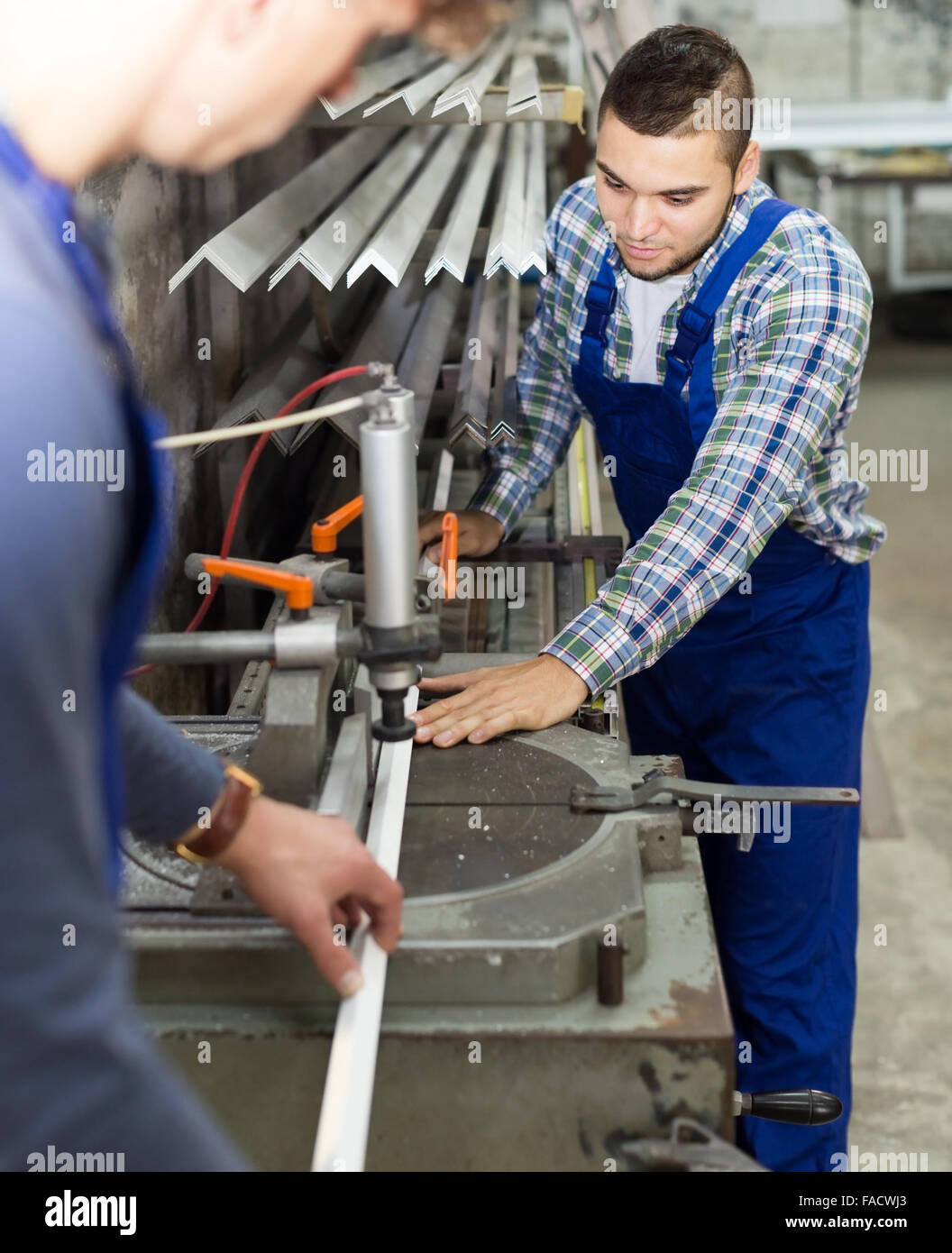A couple of happy adult men working around the milling machine Stock ...
