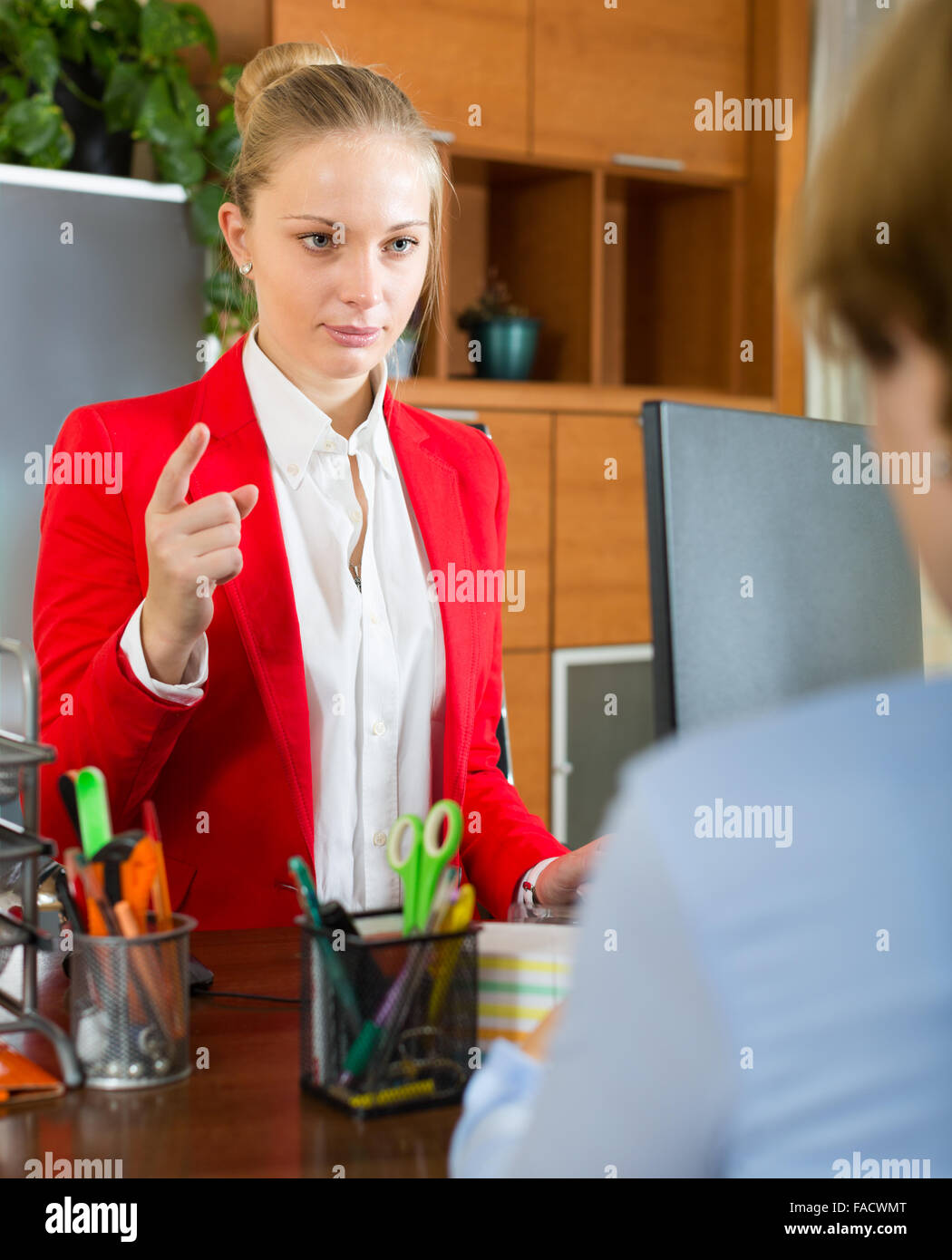 Businesswoman having difficult conversation with employee Stock Photo ...