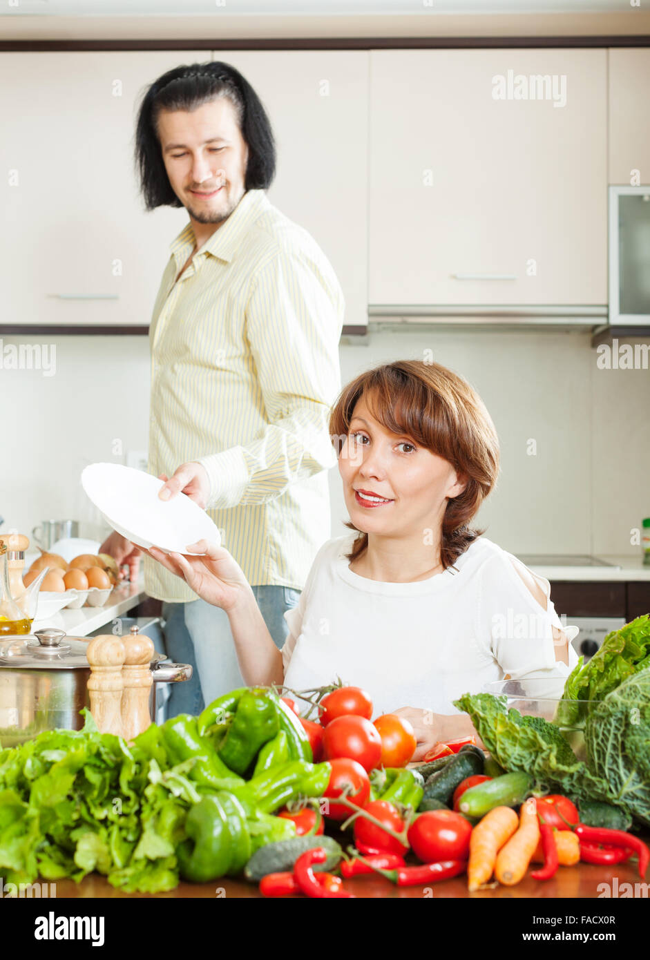 happy couple doing housework together in home kitchen Stock Photo - Alamy
