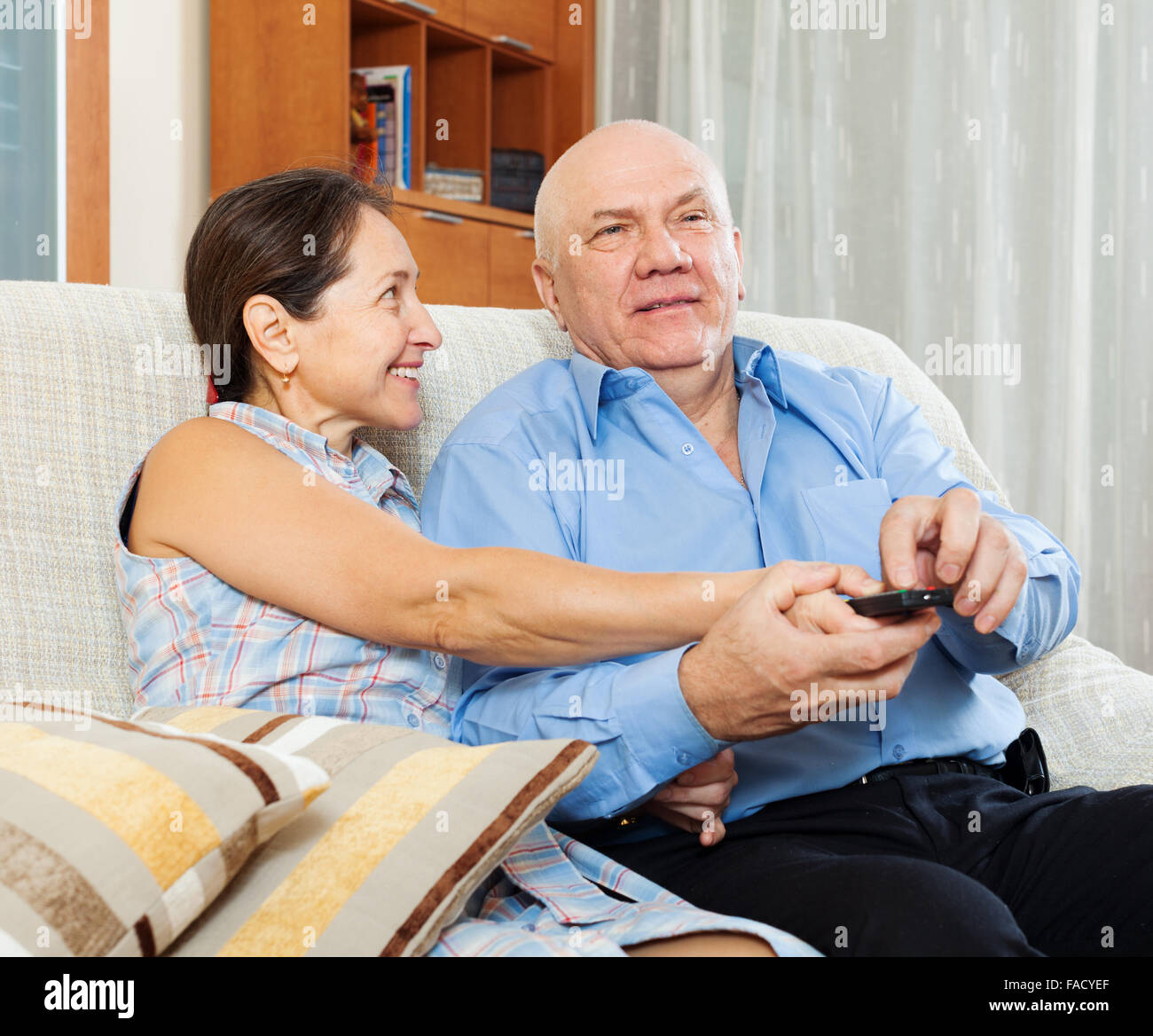 mature couple relaxing with TV remote together Stock Photo - Alamy