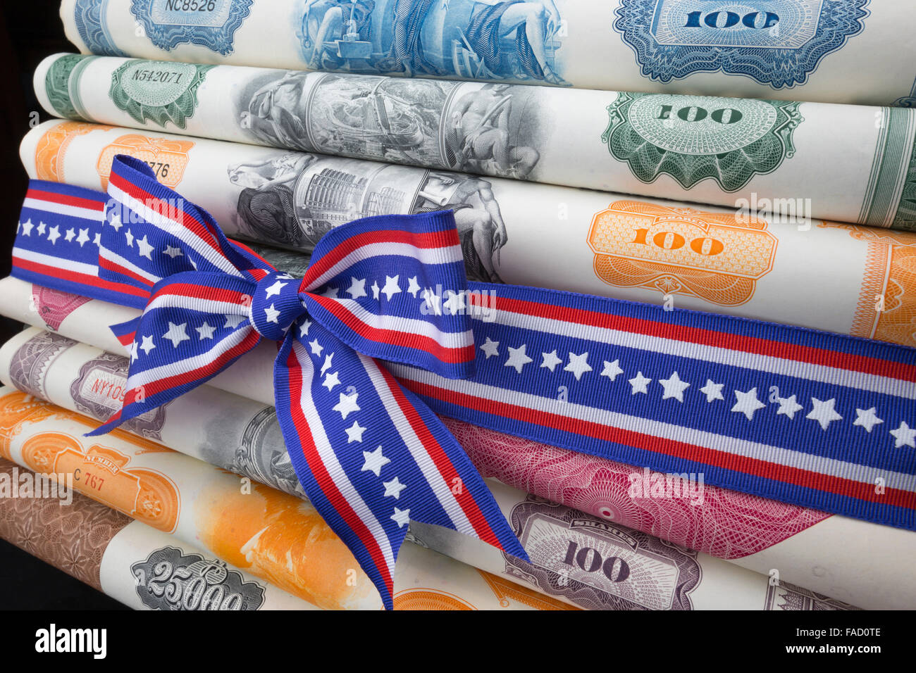 RED WHITE AND BLUE BIRTHDAY PRESENT RIBBON AROUND PAPER BONDS AND STOCK ...