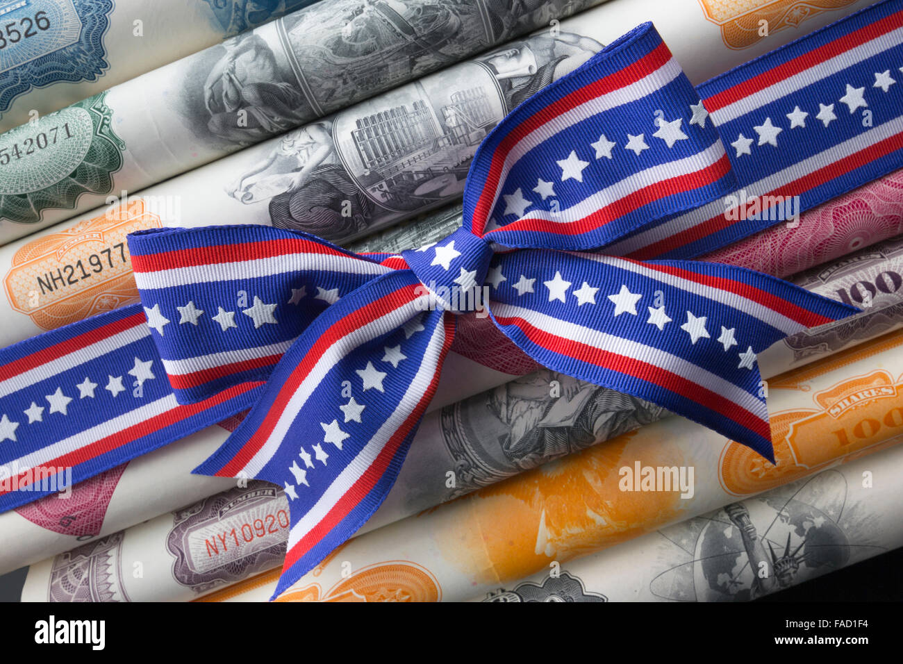 RED WHITE AND BLUE BIRTHDAY PRESENT RIBBON AROUND PAPER BONDS AND STOCK ...