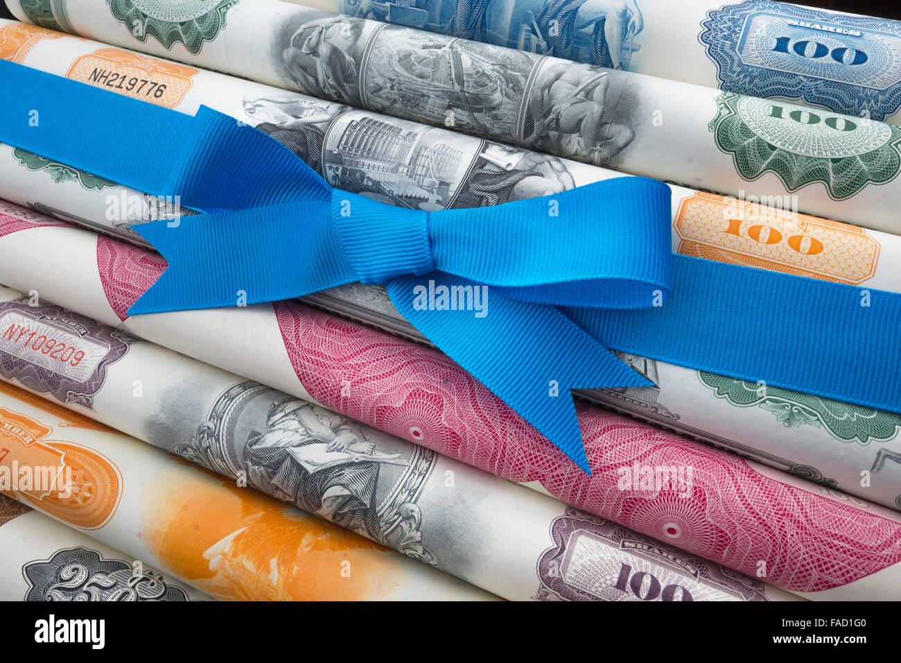 BLUE BIRTHDAY PRESENT RIBBON AROUND PAPER BONDS AND STOCK CERTIFICATES ...