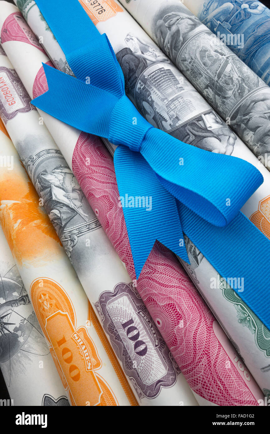 BLUE BIRTHDAY PRESENT RIBBON AROUND PAPER BONDS AND STOCK CERTIFICATES ...