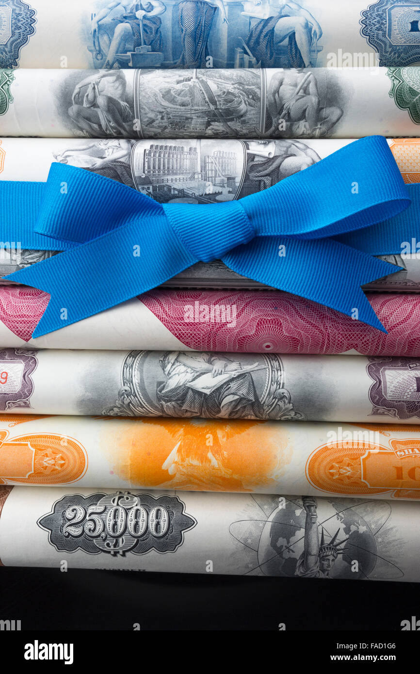 BLUE BIRTHDAY PRESENT RIBBON AROUND PAPER BONDS AND STOCK CERTIFICATES ...