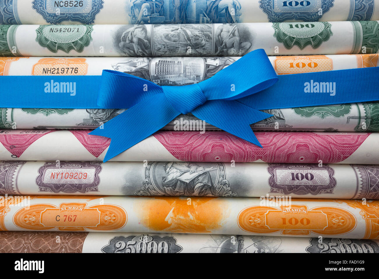 BLUE BIRTHDAY PRESENT RIBBON AROUND PAPER BONDS AND STOCK CERTIFICATES ...