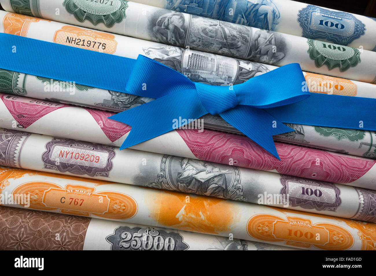 BLUE BIRTHDAY PRESENT RIBBON AROUND PAPER BONDS AND STOCK CERTIFICATES ...