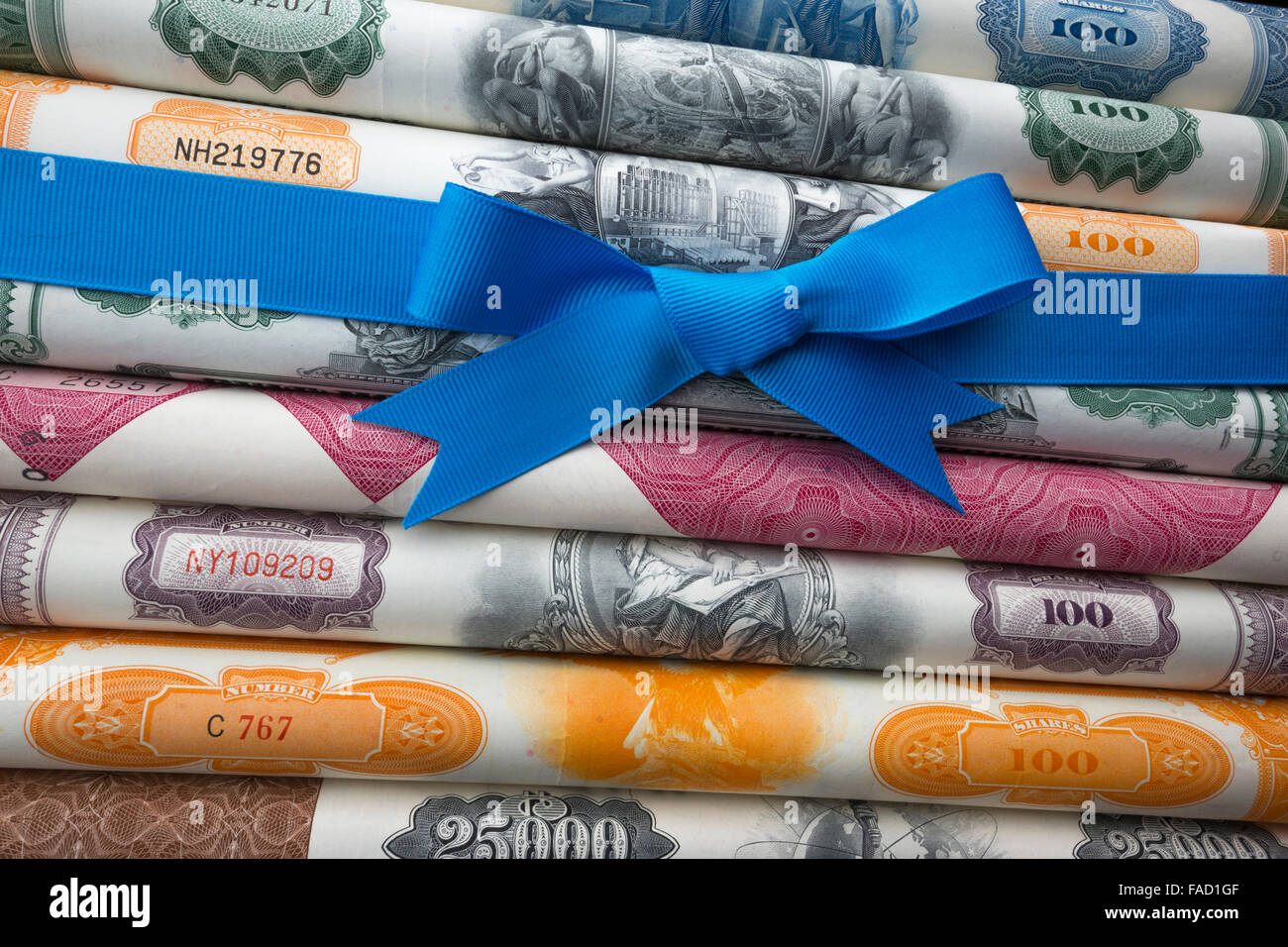 BLUE BIRTHDAY PRESENT RIBBON AROUND PAPER BONDS AND STOCK CERTIFICATES ...