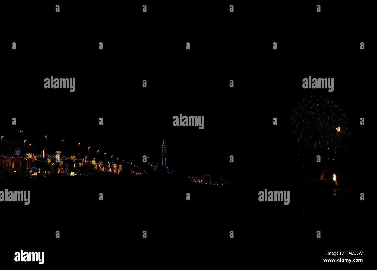Night view Queen's Promenade Cliffs south to multi-colours Blackpool ...
