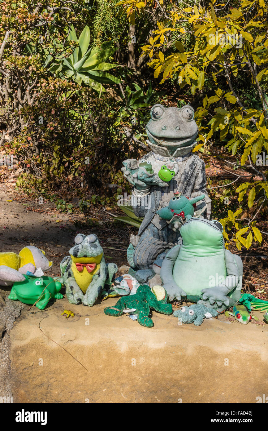 The very unique and fanciful "frog shrine" located on a low rock wall ...