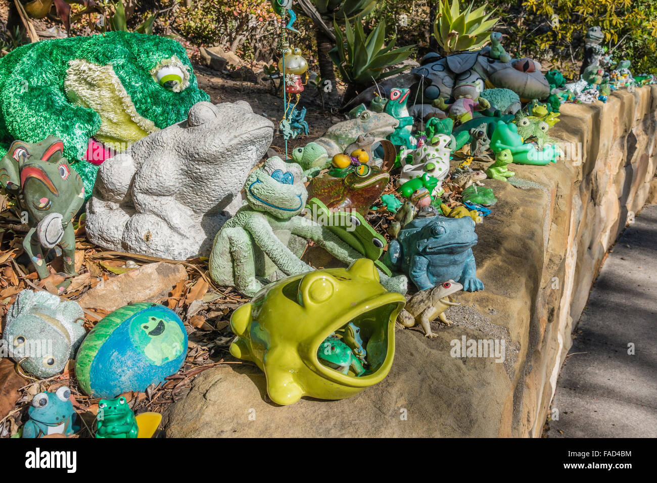 The very unique and fanciful "frog shrine" located on a low rock wall ...