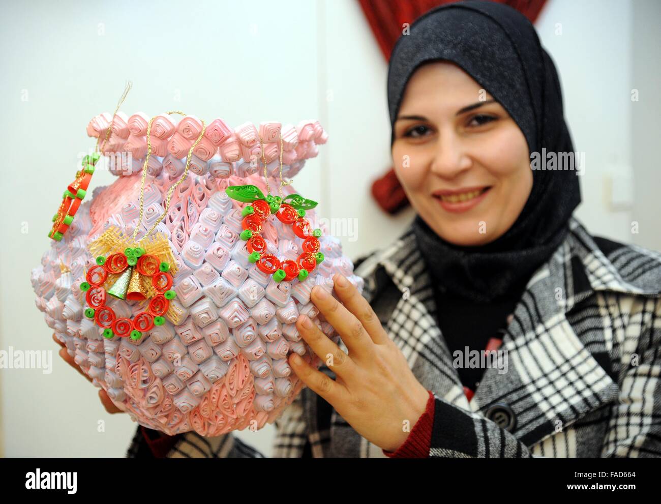 Damascus. 27th Dec, 2015. A single Syrian mom shows a hand-made basket ...