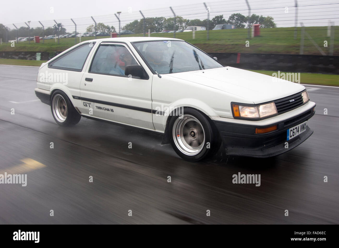 Toyota AE86 Levin modern classic car driving in the rain Stock Photo ...