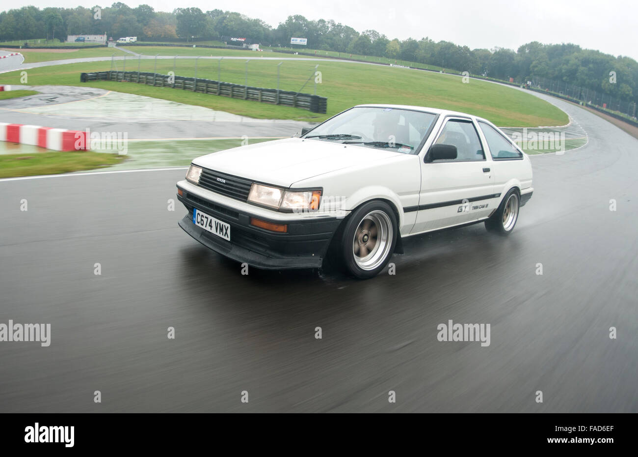Toyota AE86 Levin modern classic car driving in the rain Stock Photo ...