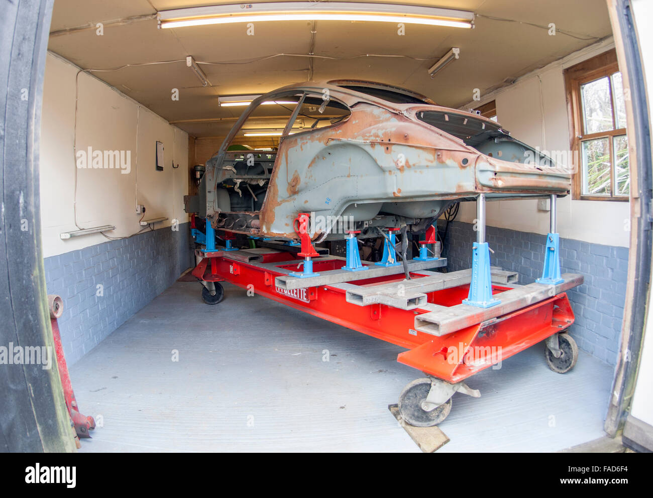 Porsche 911 bare bodyshell on a jig at a bodyshop Stock Photo - Alamy