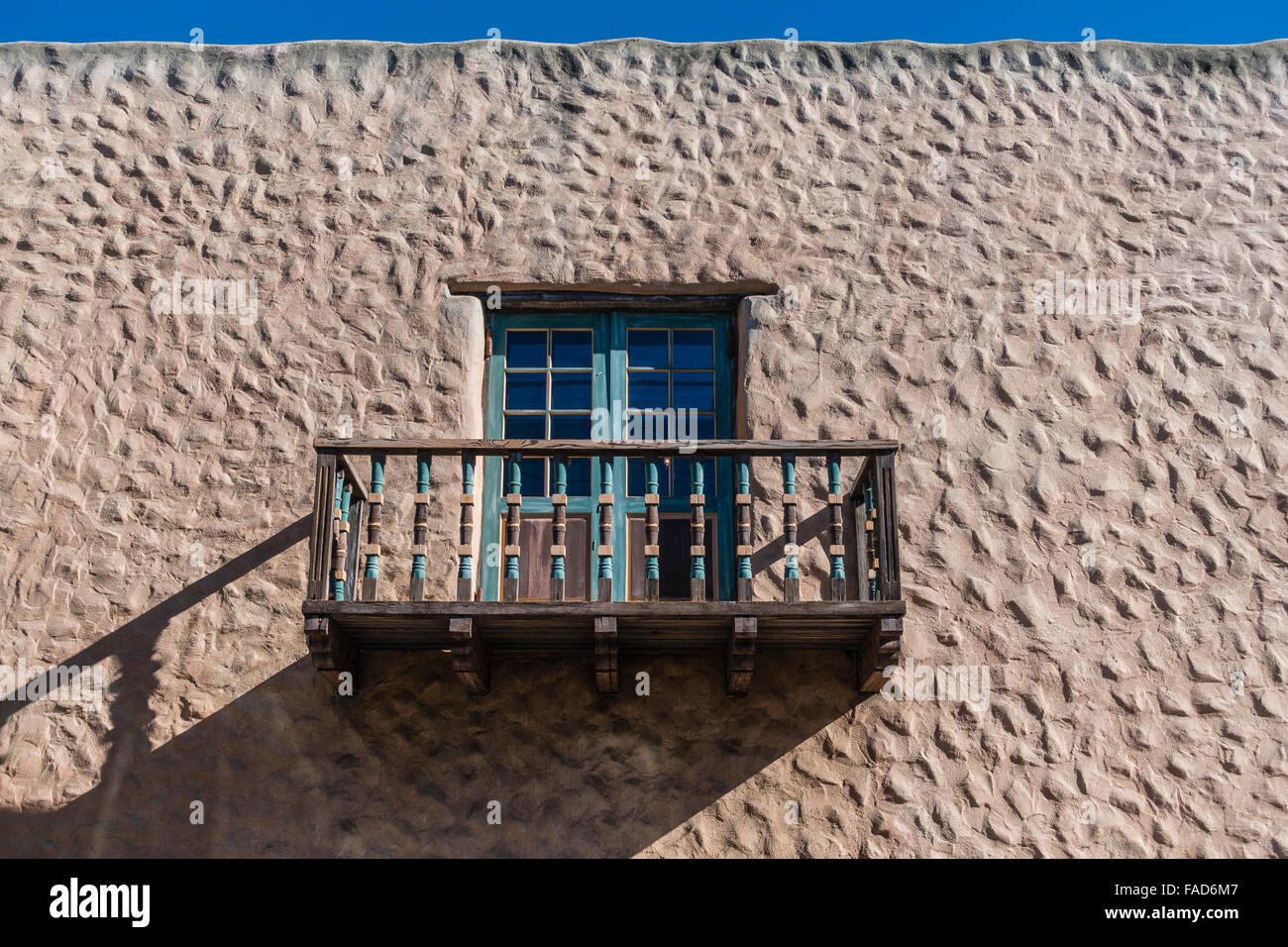 Decorative wooden second story balcony with multi-color painted ...