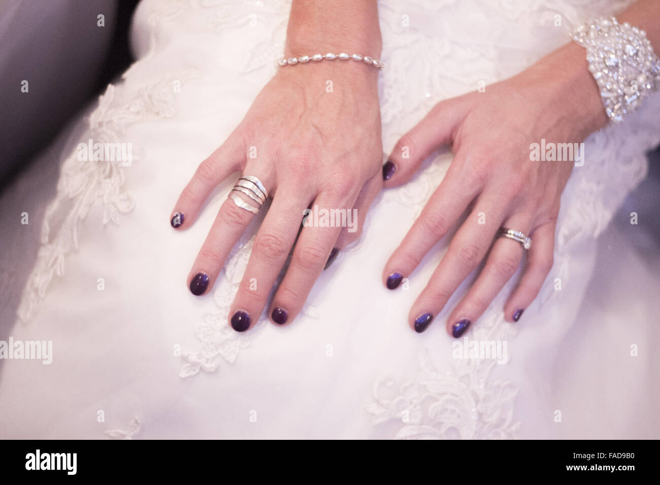 Bride in white dress with wedding ring sitting in reception party Stock ...