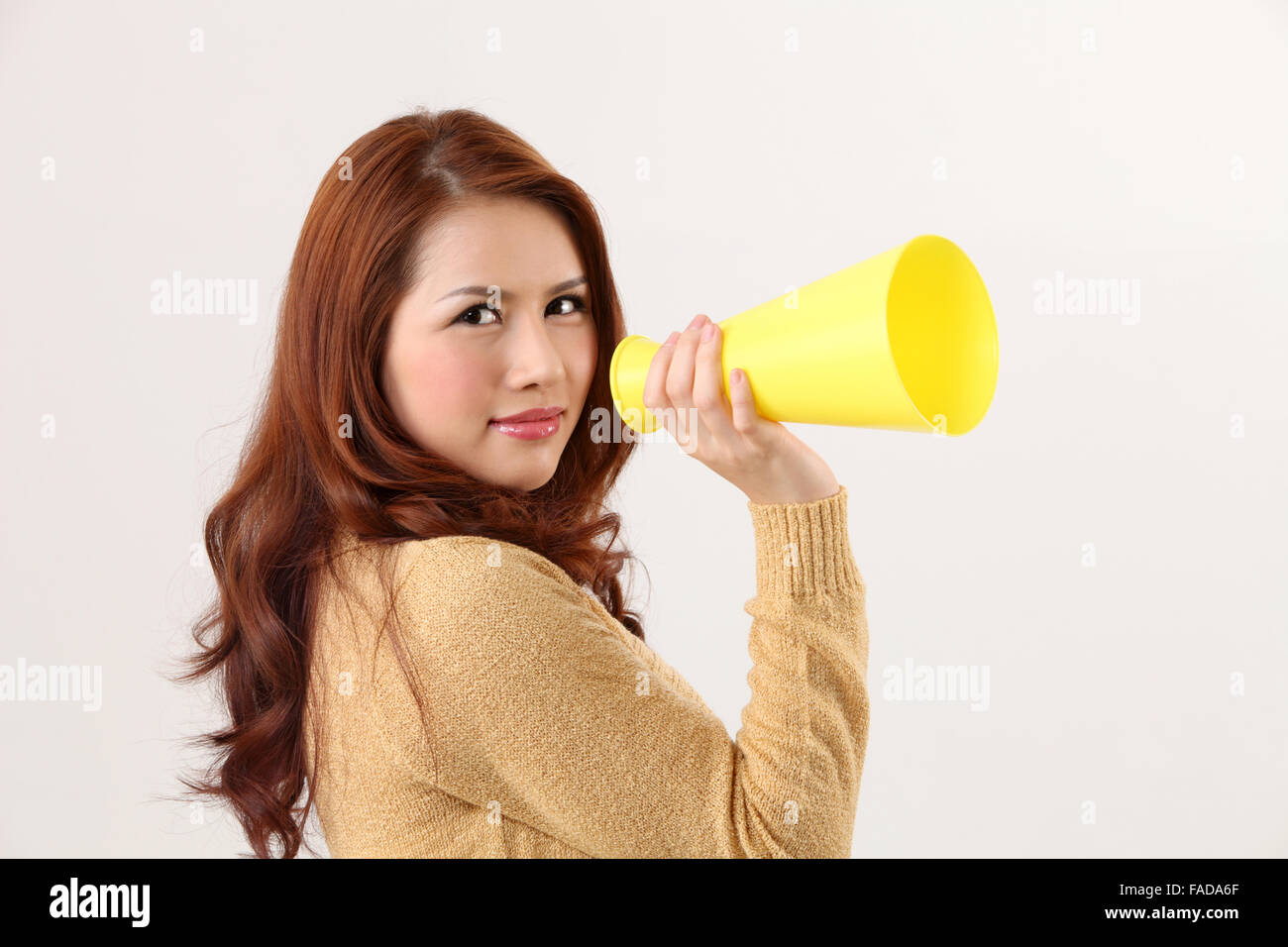 Woman screaming into bullhorn Stock Photo - Alamy