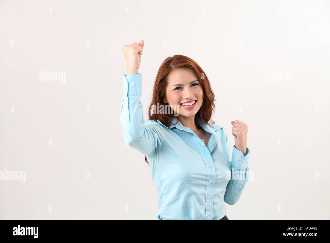 office lady with arm raising- cheerful Stock Photo - Alamy