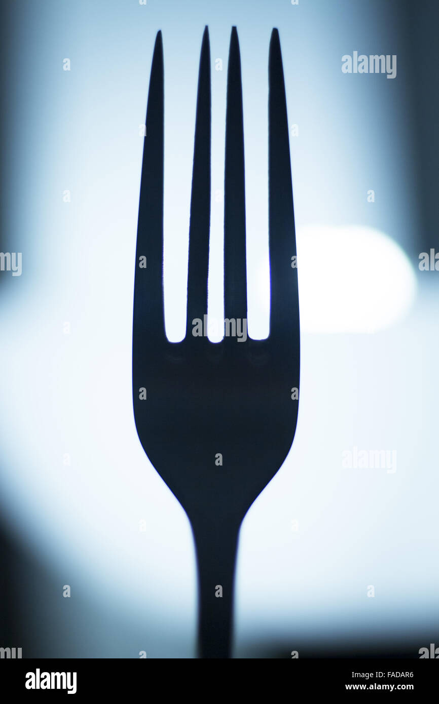 Fork silhouette at night symbolic artistic photograph Stock Photo - Alamy