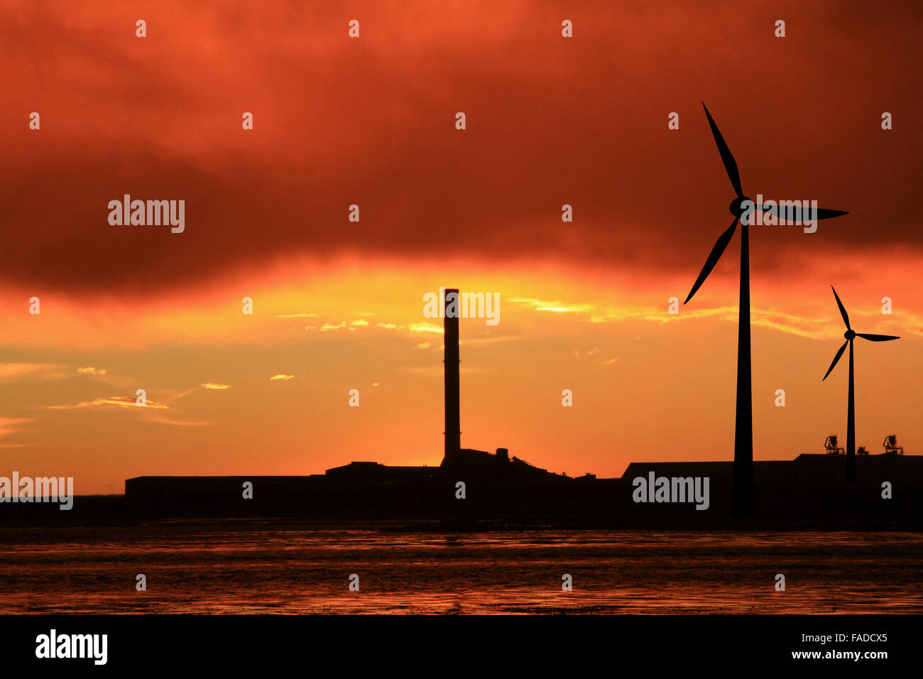 a vibrant sunrise and wind turbines in background Stock Photo - Alamy