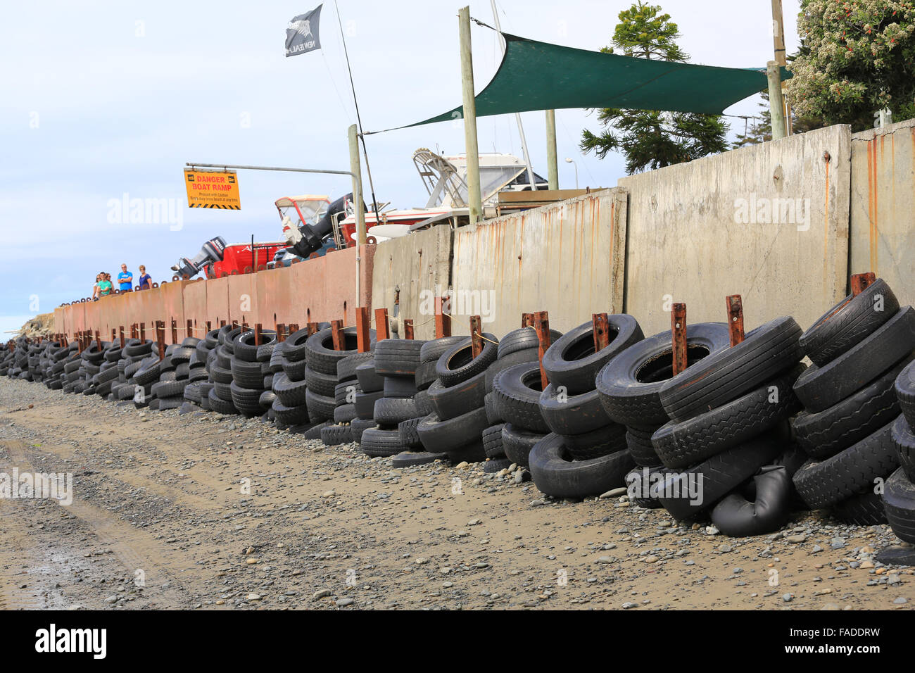 Old car tire wave suppressor along the seawall at Clifton, Hawke's Bay ...