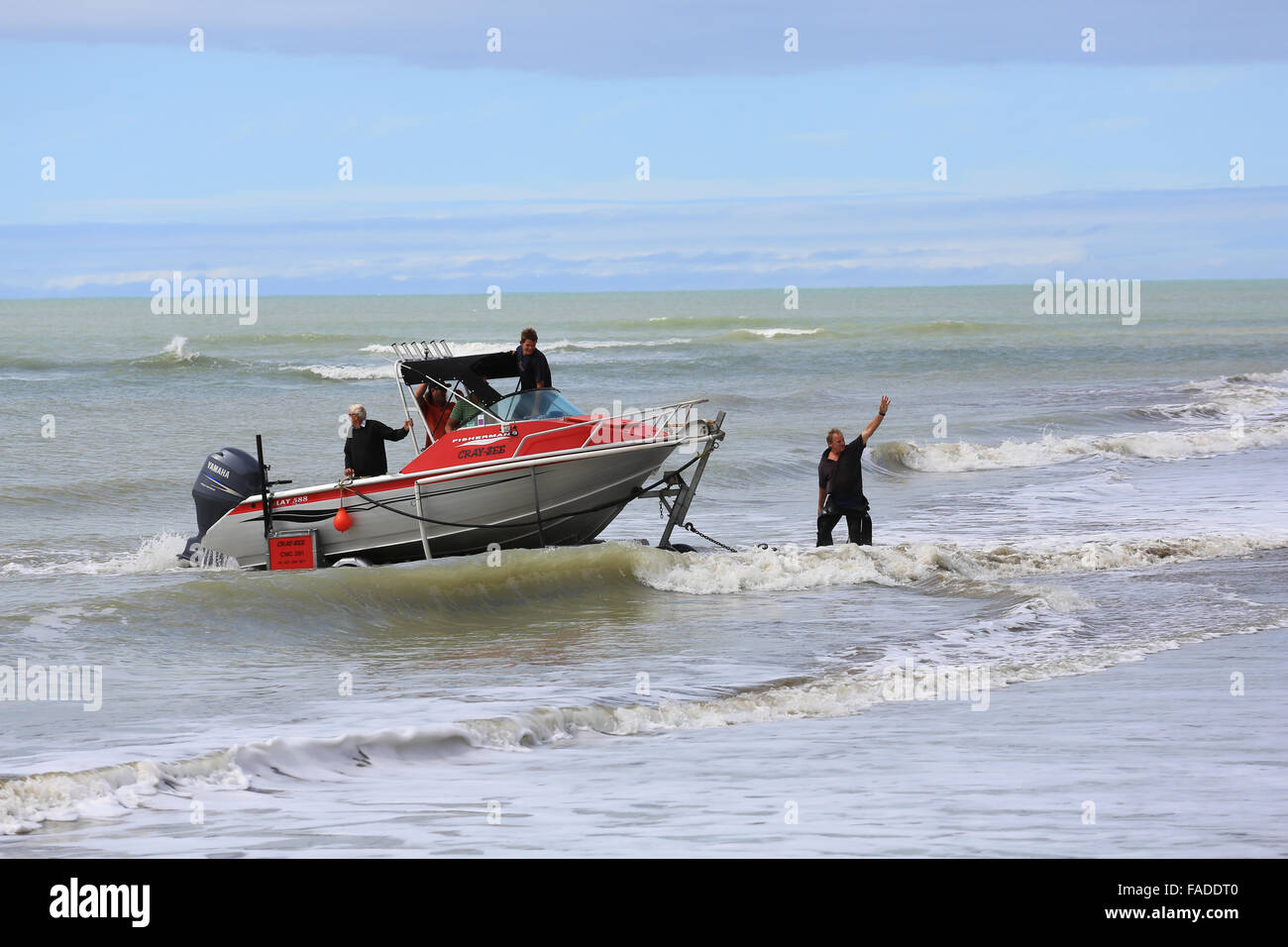 A McLay Fisherman boat is hauled out of the water across the beach on a ...