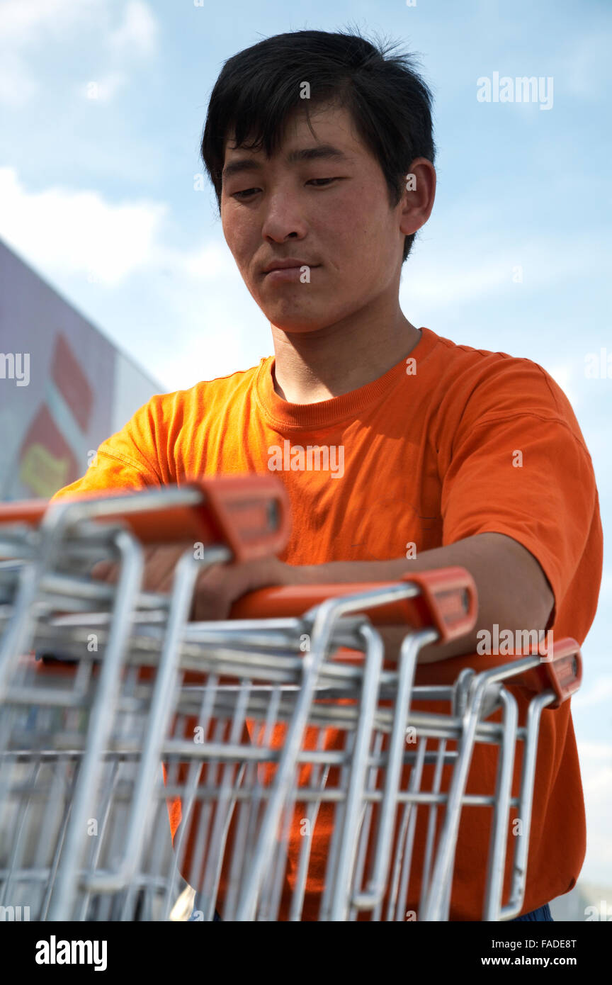 Working boy driving a number of trolleys Stock Photo - Alamy