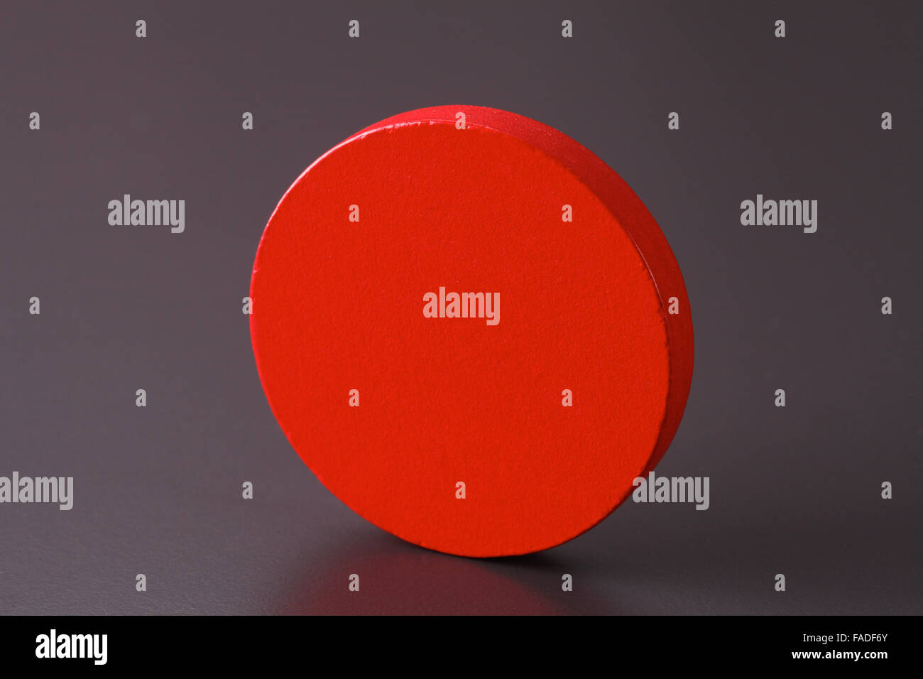 a red round wooden block Stock Photo - Alamy